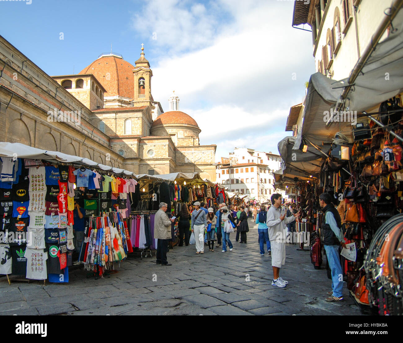 People shopping at a street market on a cobbled street in Florence ...