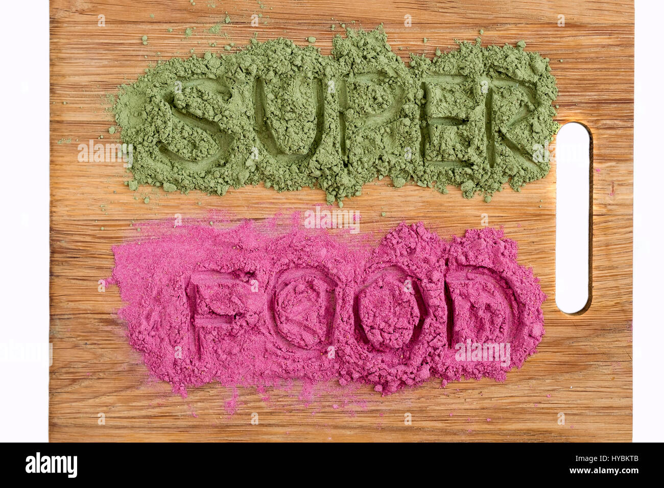 Superfood word with green and pink powders on wooden board. Healthy ...