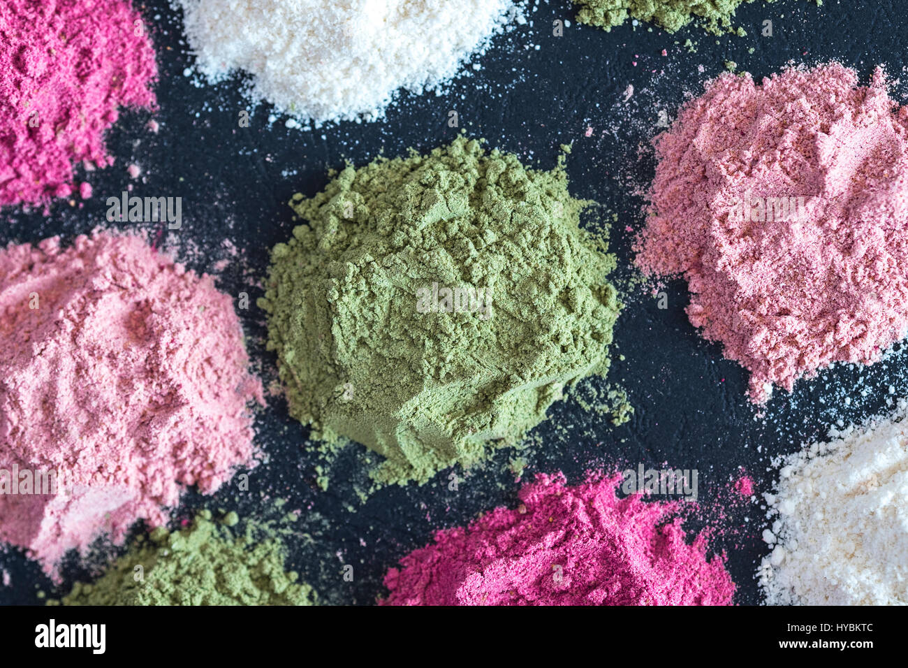 Various colorful superfood powders on dark background. Healthy food ...