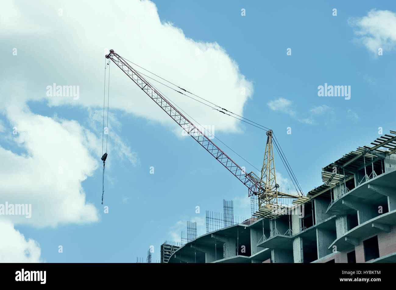 Building with elevating crane Stock Photo - Alamy