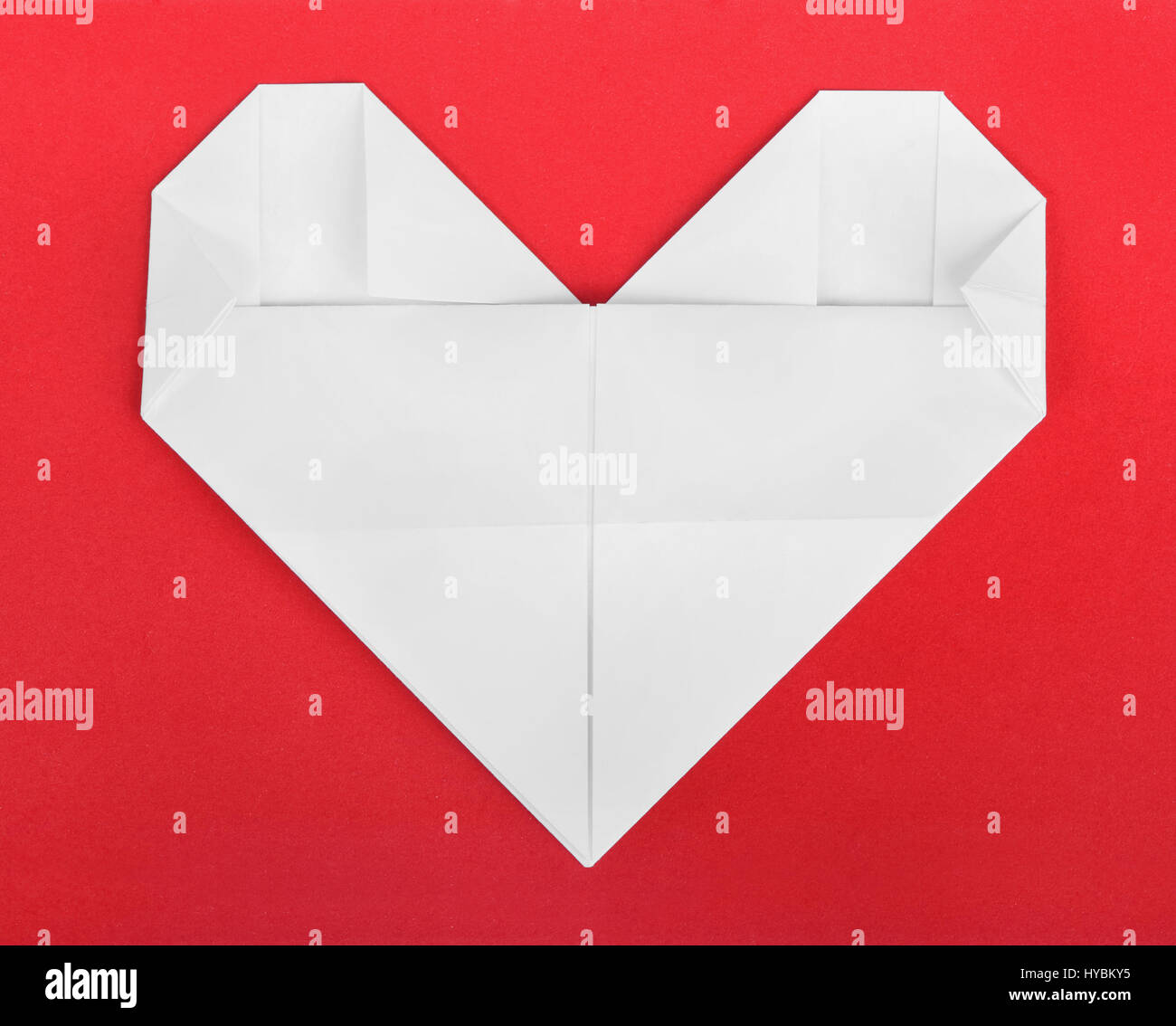 White paper heart shape origami on red Stock Photo - Alamy