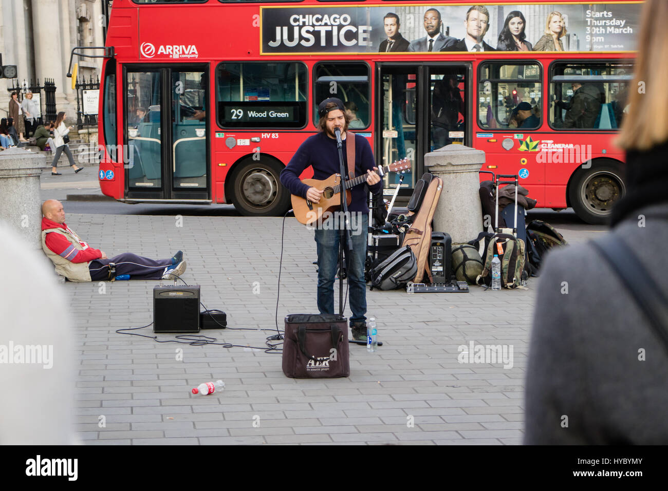 Street musician/ performer/ singer performing with guitar in Trafalgar ...