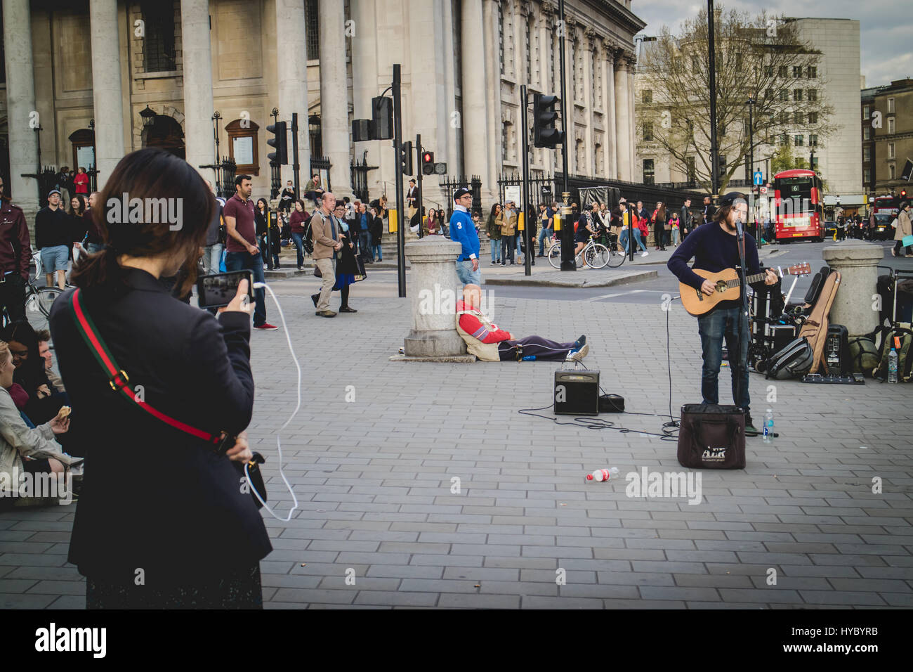 Street musician/ performer/ singer performing with guitar in Trafalgar ...