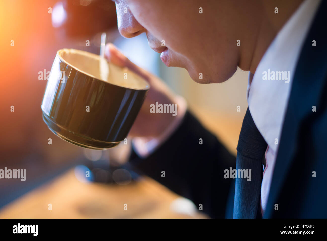 asian businessm male drinking coefee close up Stock Photo - Alamy