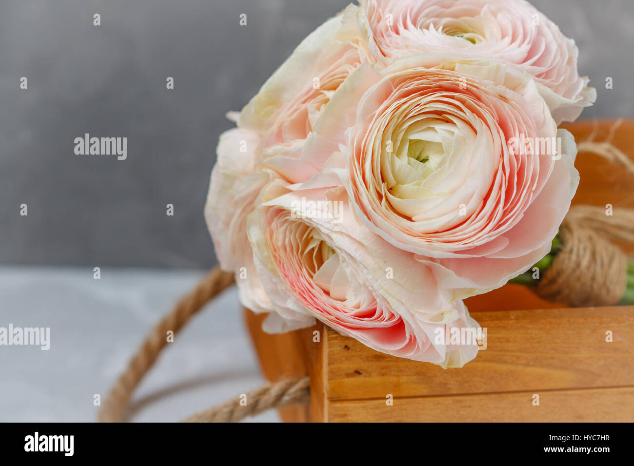 Ranunculus bouquet in a wooden box on a dark grey background Stock ...