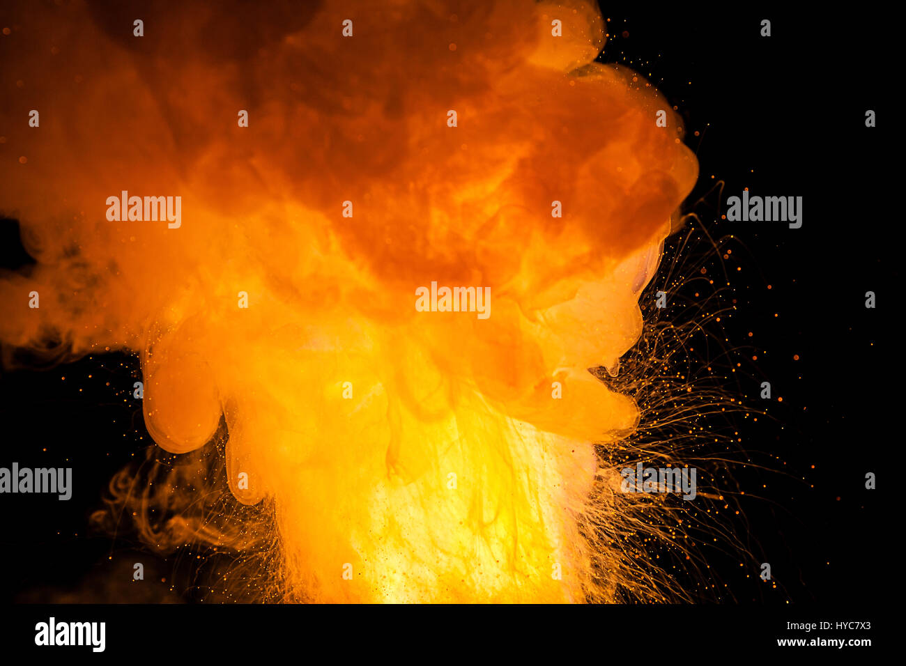 Realistic fiery explosion, orange color with sparks on a black ...