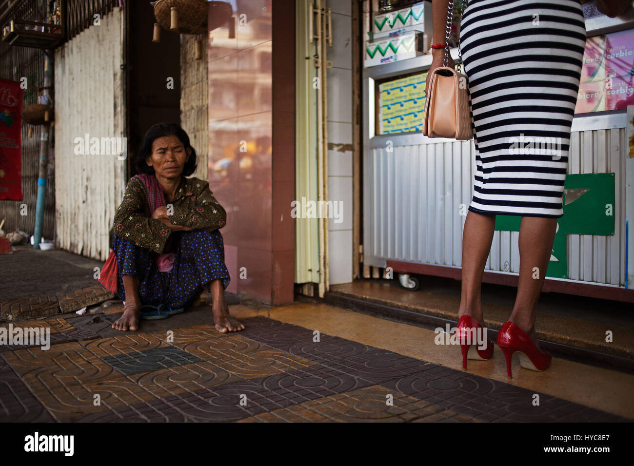 Poor woman looking at rich women stiletto, phnom penh, cambodia Stock ...