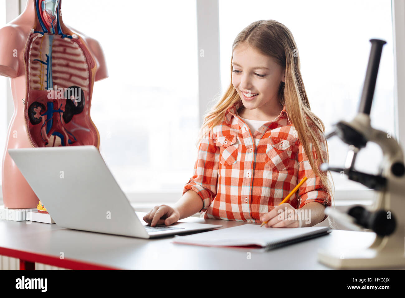 Sweet clever girl using her computer for data analysis Stock Photo - Alamy