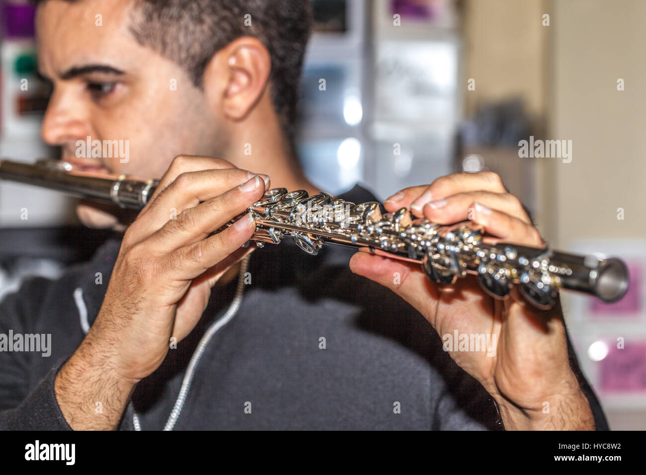 young man playing the flute instrument Stock Photo - Alamy