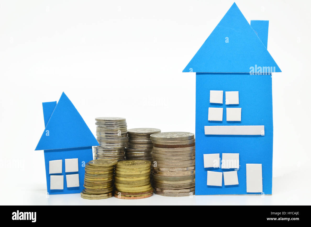 Blue paper house model and stacks of coins Stock Photo - Alamy
