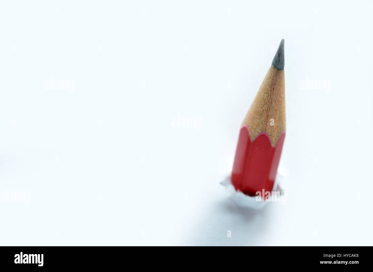 Red pencil going through a white torn paper Stock Photo - Alamy