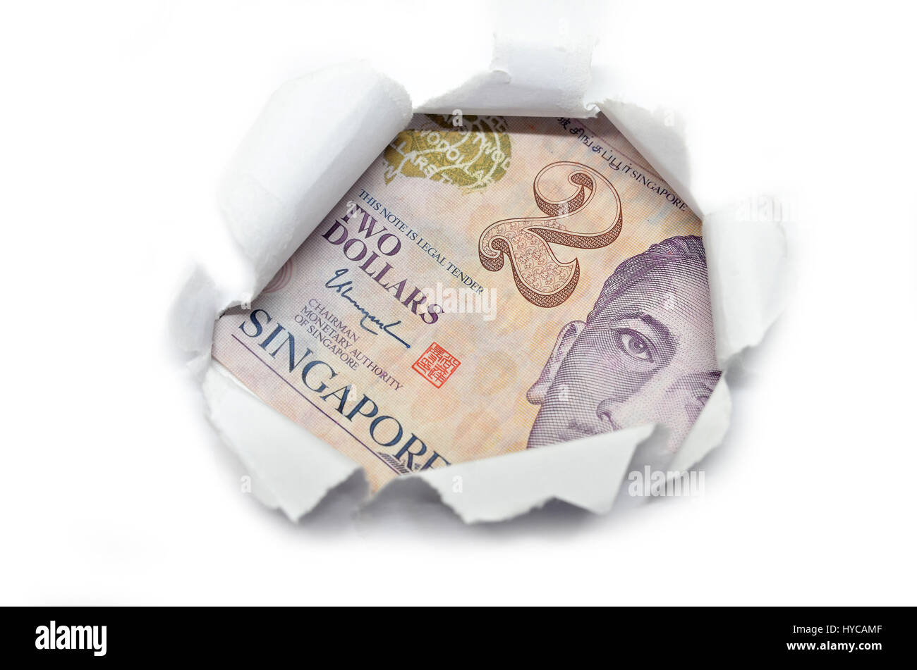 Singapore currency macro peeking through torn white paper Stock Photo ...
