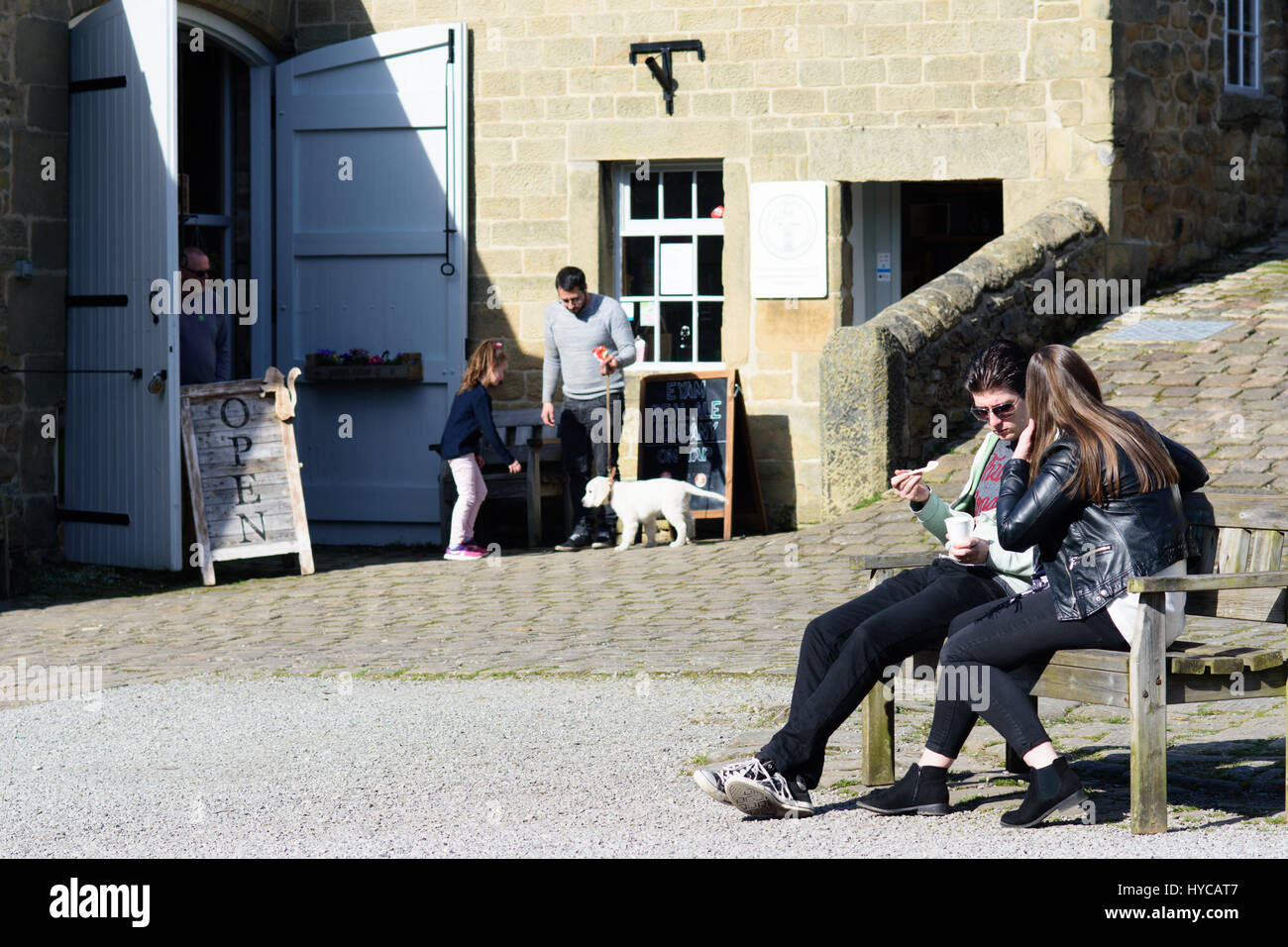 young couple sat down Stock Photo - Alamy