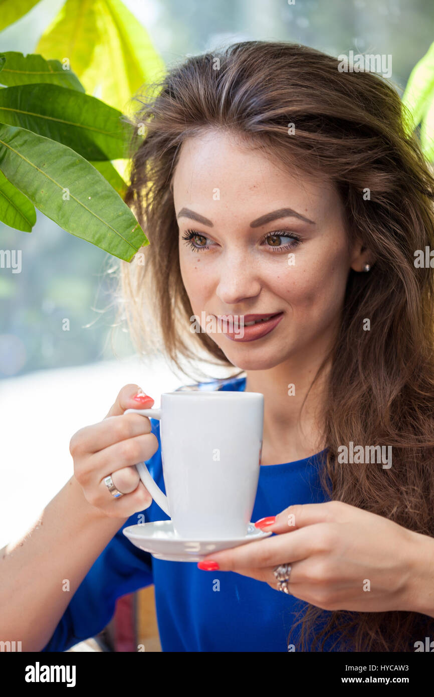 Pretty woman drinking a cup of coffee. Coffee drinker Stock Photo - Alamy