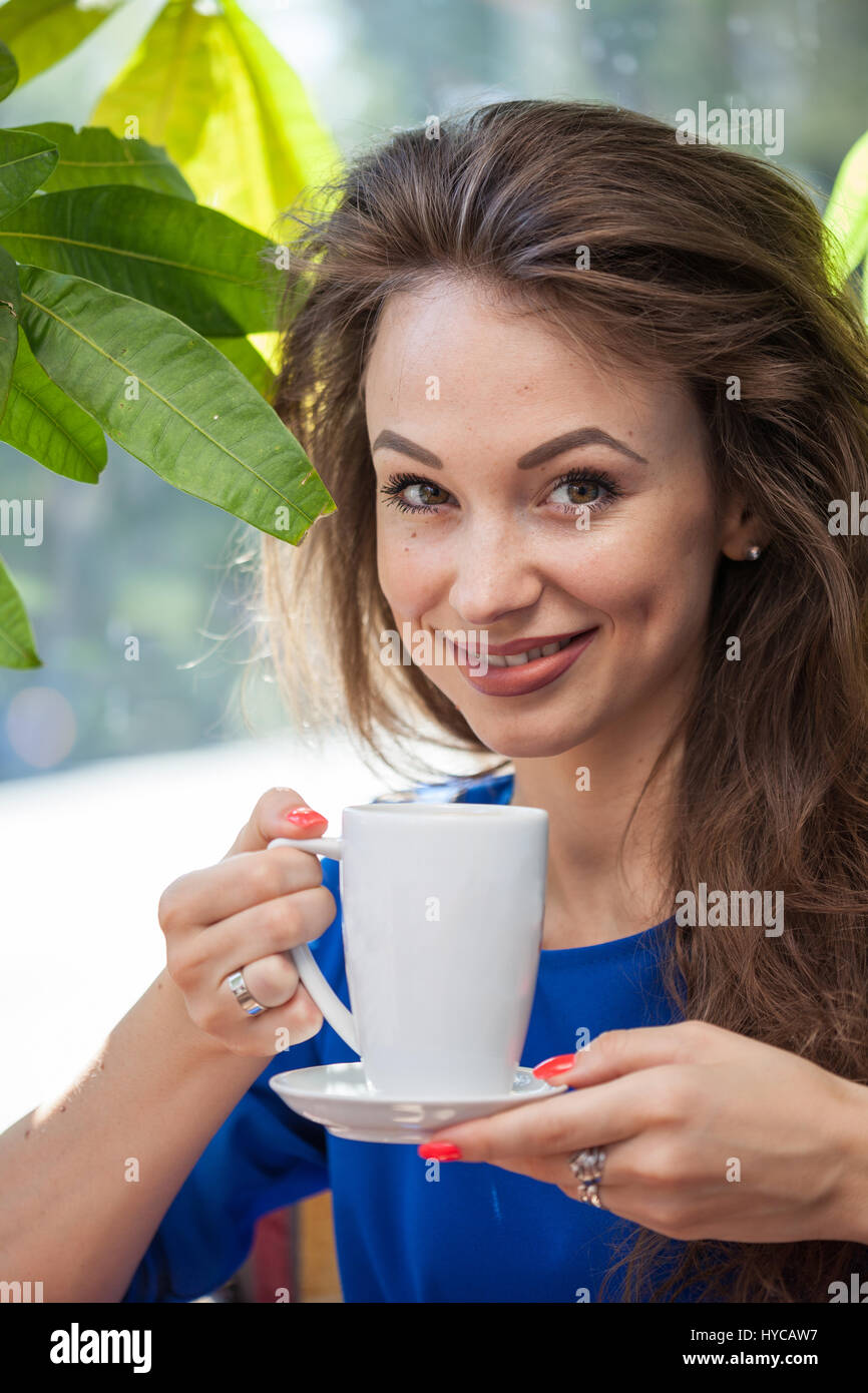 Pretty woman drinking a cup of coffee. Coffee drinker Stock Photo - Alamy