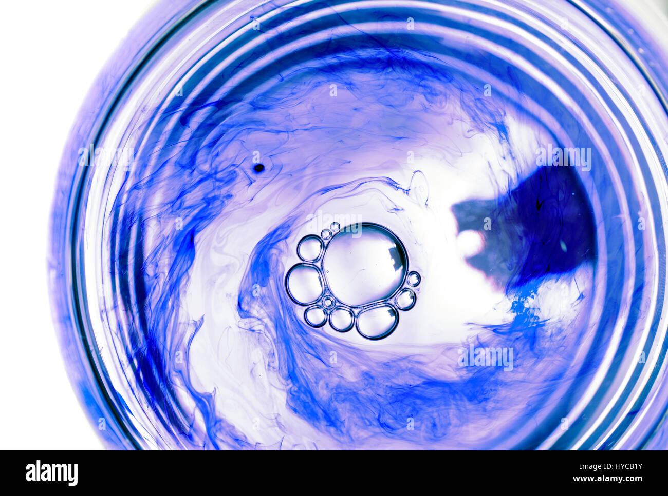 moving ink in water spiral abstract, purple and white Stock Photo - Alamy