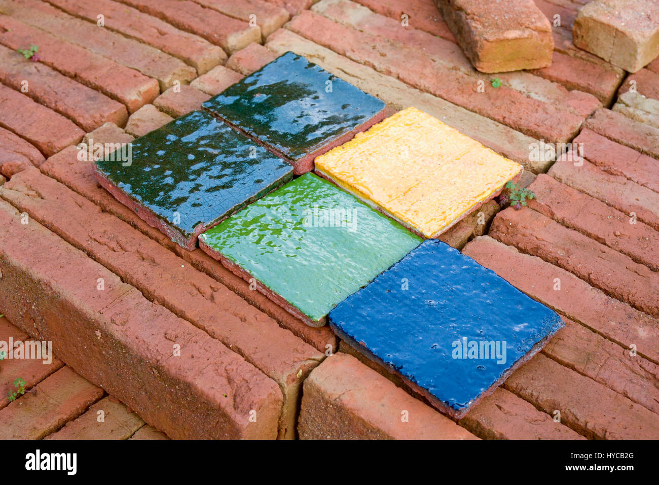 Stack of reclaimed bricks and five colour tiles ready to be sold as ...