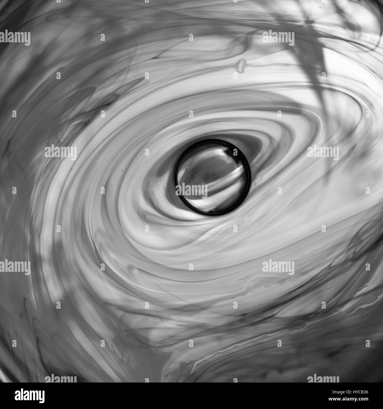 moving ink in water spiral abstract, black and white Stock Photo - Alamy
