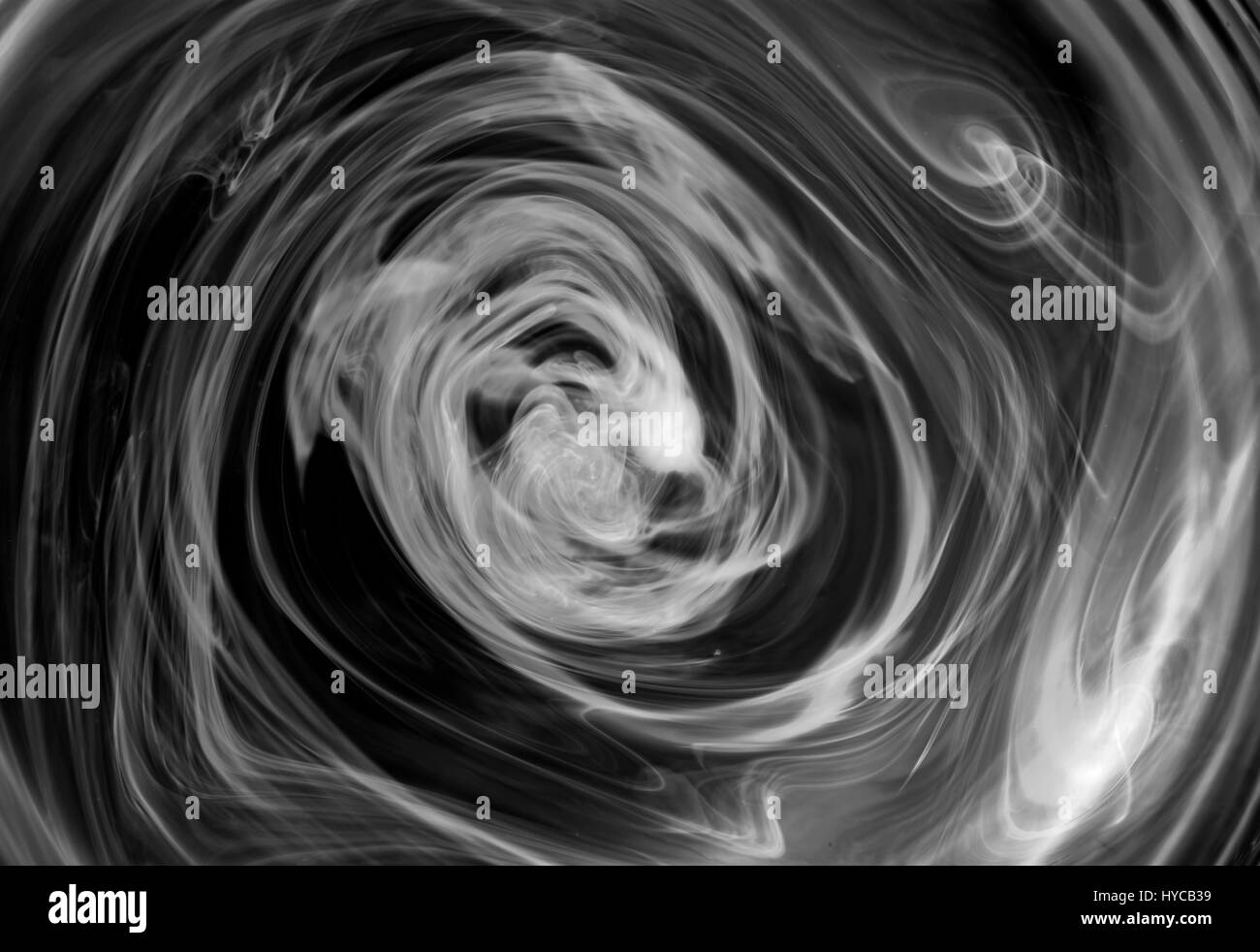 moving ink in water spiral abstract, black and white Stock Photo - Alamy
