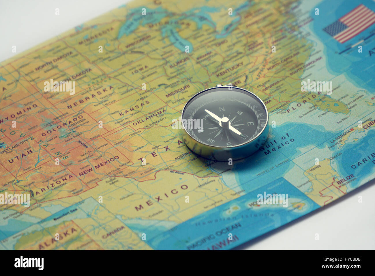 Compass with a map under Stock Photo - Alamy