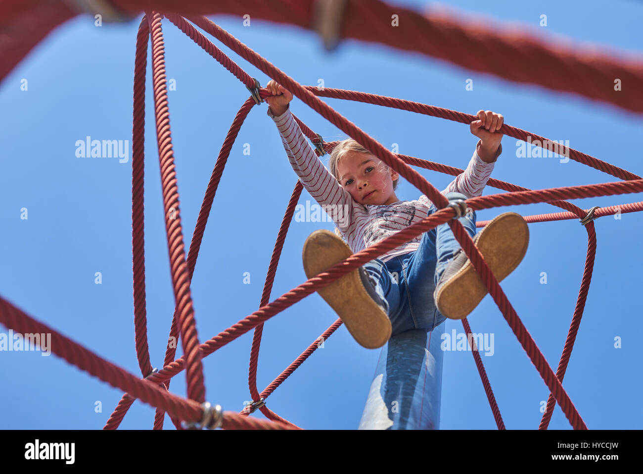 Active young child girl climbing the spider web playground activity ...
