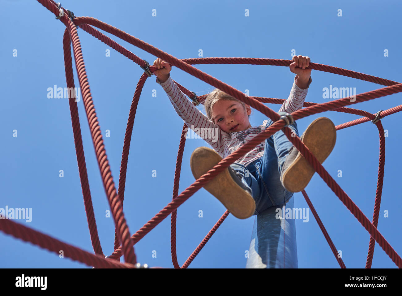 Active young child girl climbing the spider web playground activity ...