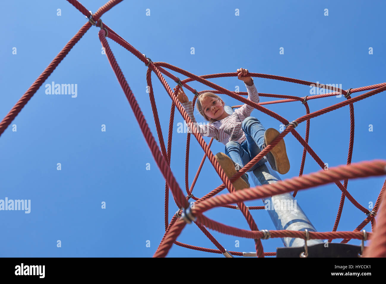 Active young child girl climbing the spider web playground activity ...