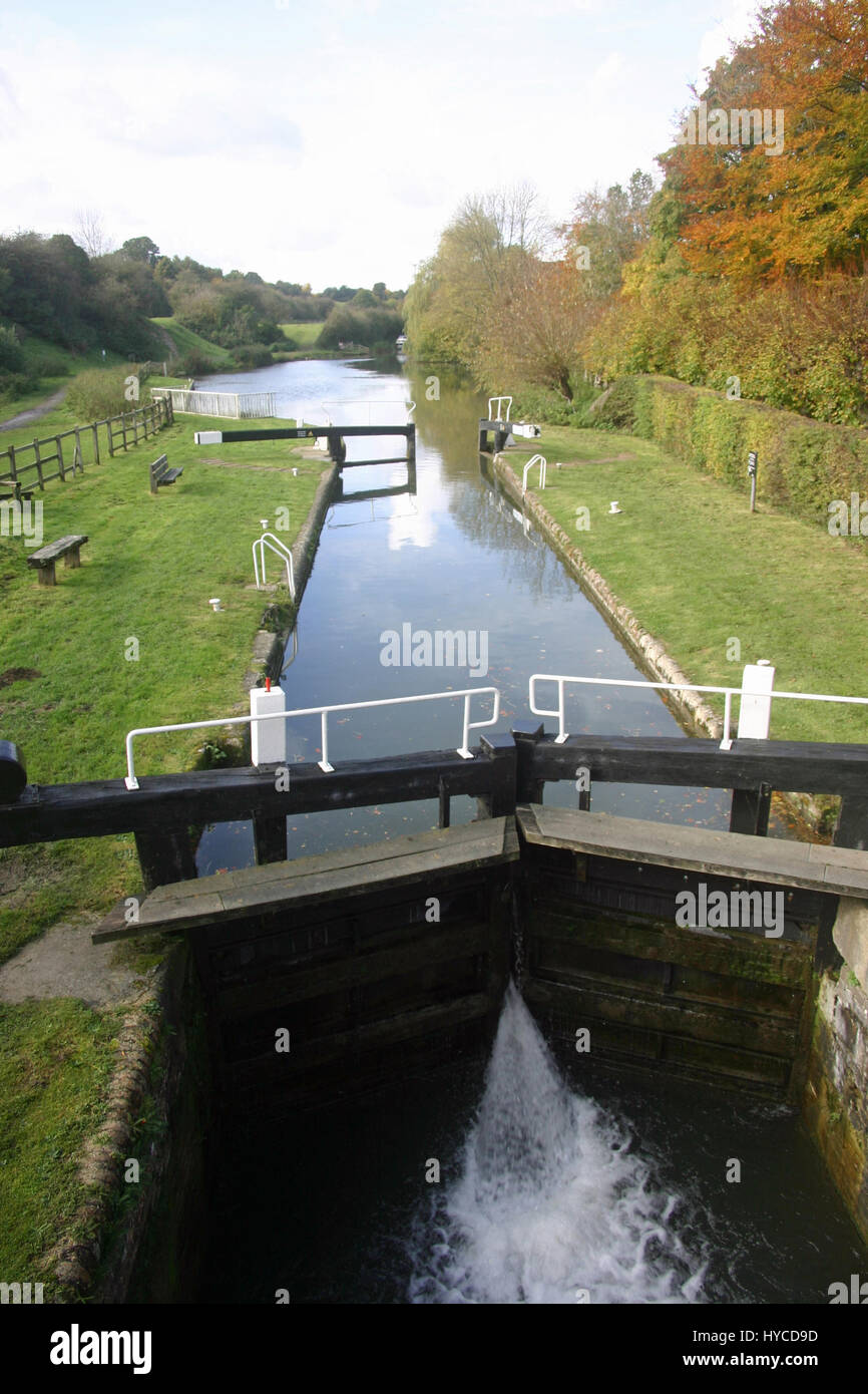 Canal with lock and gates open at the far end. Surrounded by grass ...