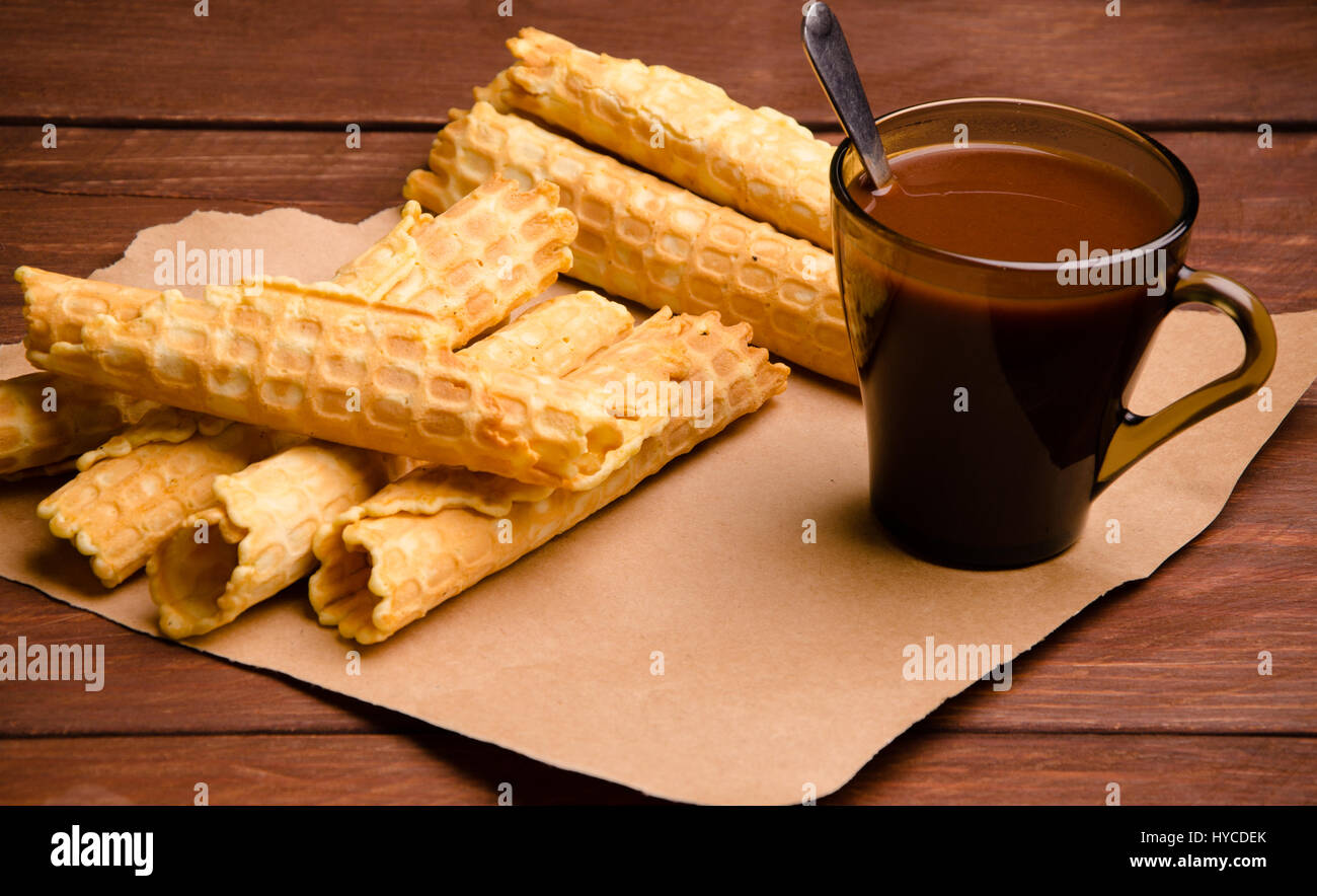 tubular wafer. waffles on wooden boards. hot chocolate Stock Photo - Alamy