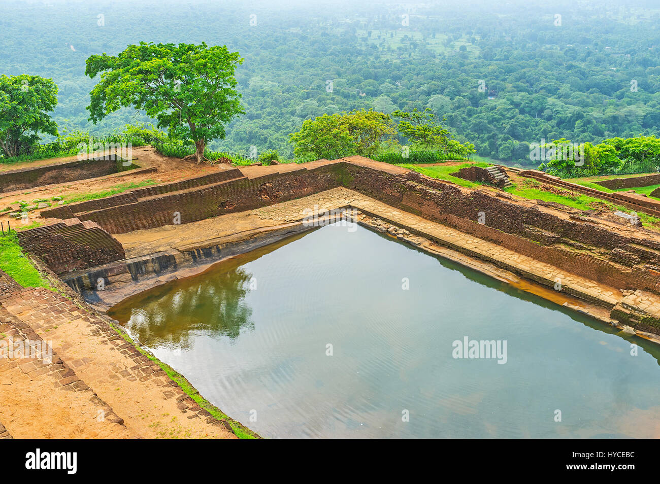 The cistern on Sigiriya rock summit is surrounded by ancient ruins of ...