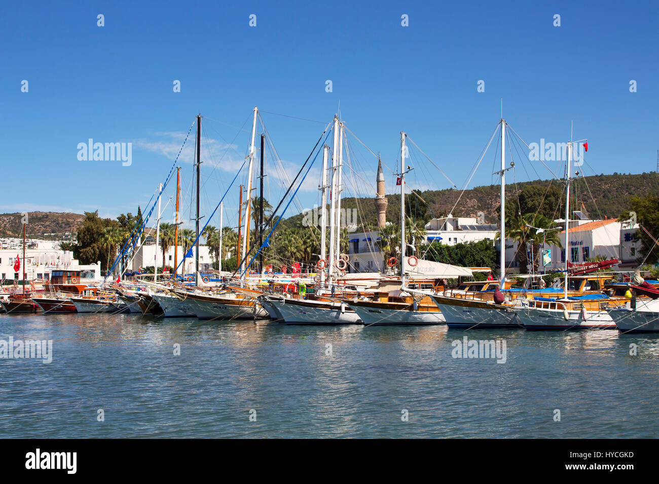 Luxury yachts and sail boats parked at Bodrum marina in a sunny summer ...