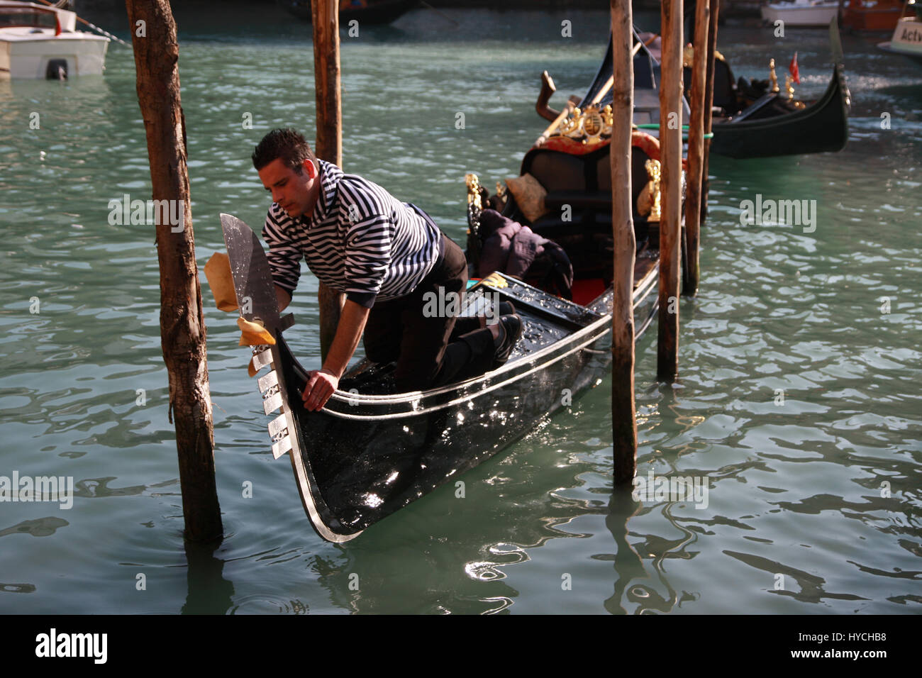 Gondolier polishing his gondola in Venice, Italy, 5th March 2011 Stock ...