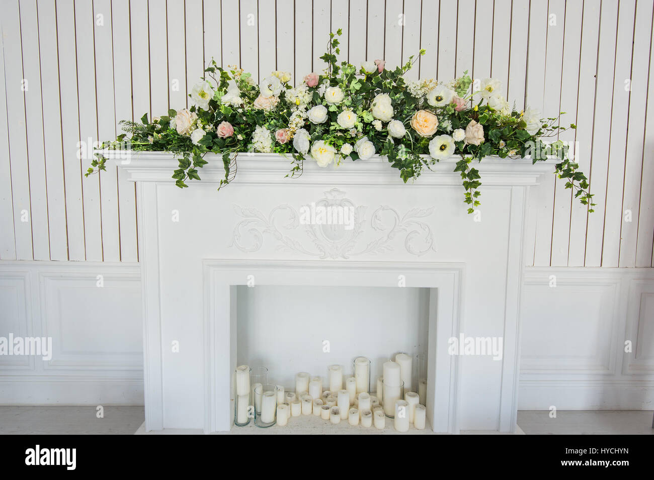 Bouquet of flowers over white fireplace in classic interior Stock Photo ...
