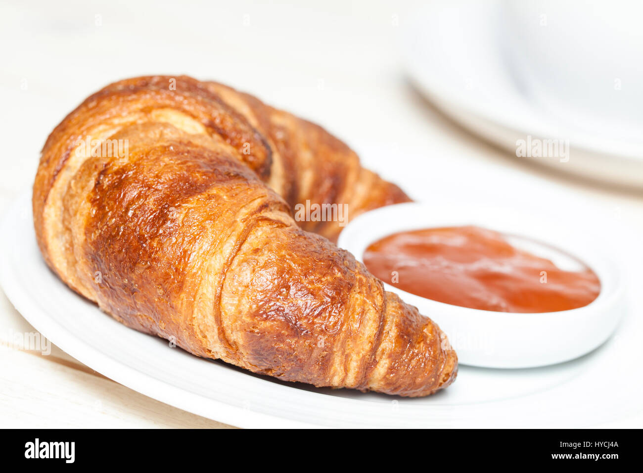 Croissant with peach jam Stock Photo - Alamy