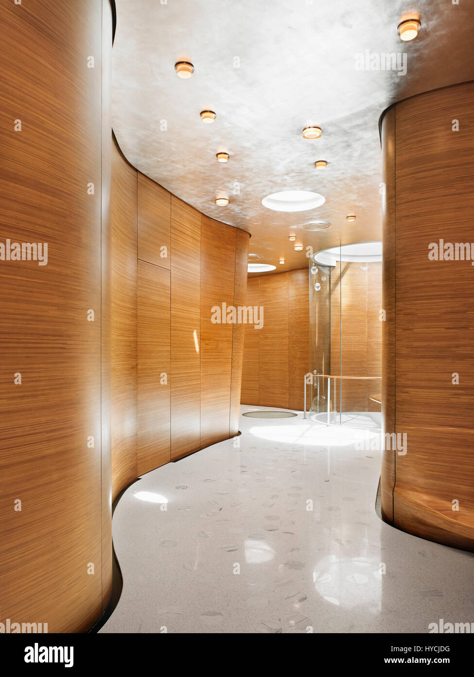 Curved bamboo walls in a ground-floor corridor leading to the elevators ...