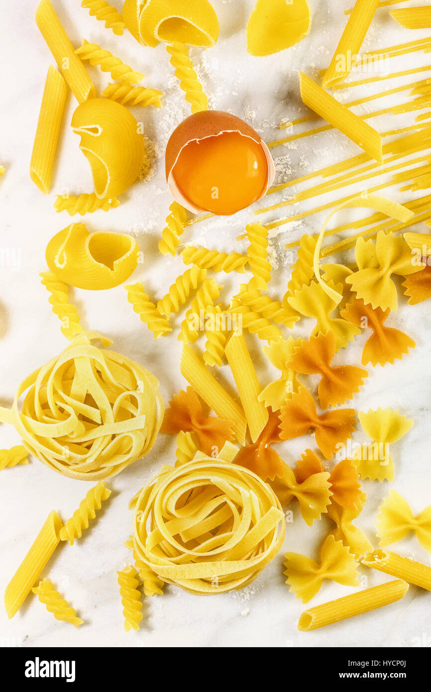 Various types of pasta on marble with egg Stock Photo - Alamy