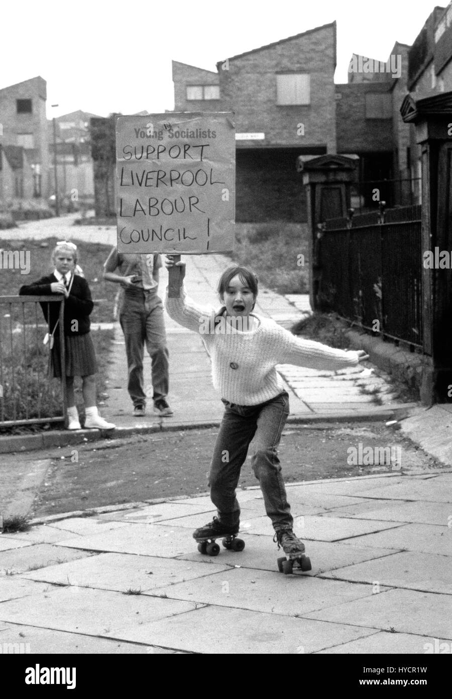 Young socialist on roller skates waving banner supporting the Militant ...