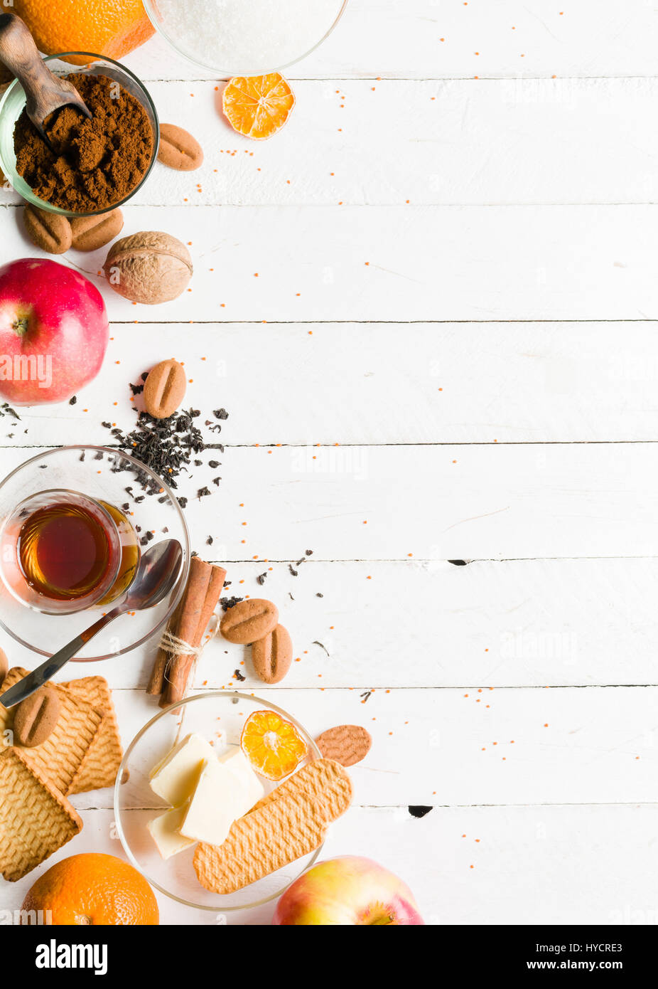 Morning tea with fruit and candied fruit. White wooden background and ...