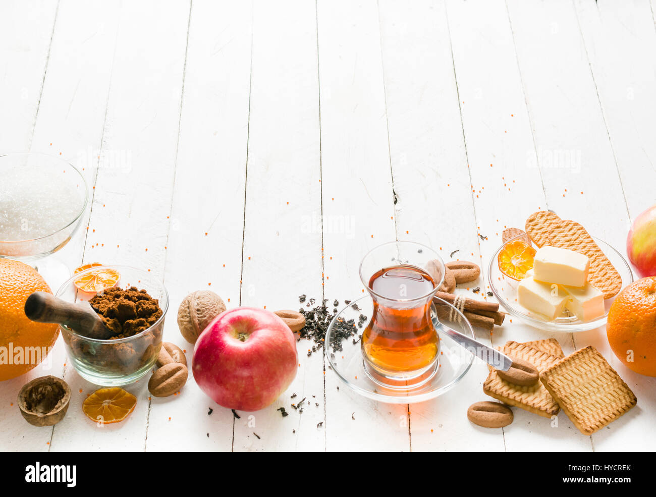 Morning tea with fruit and candied fruit. White wooden background and ...