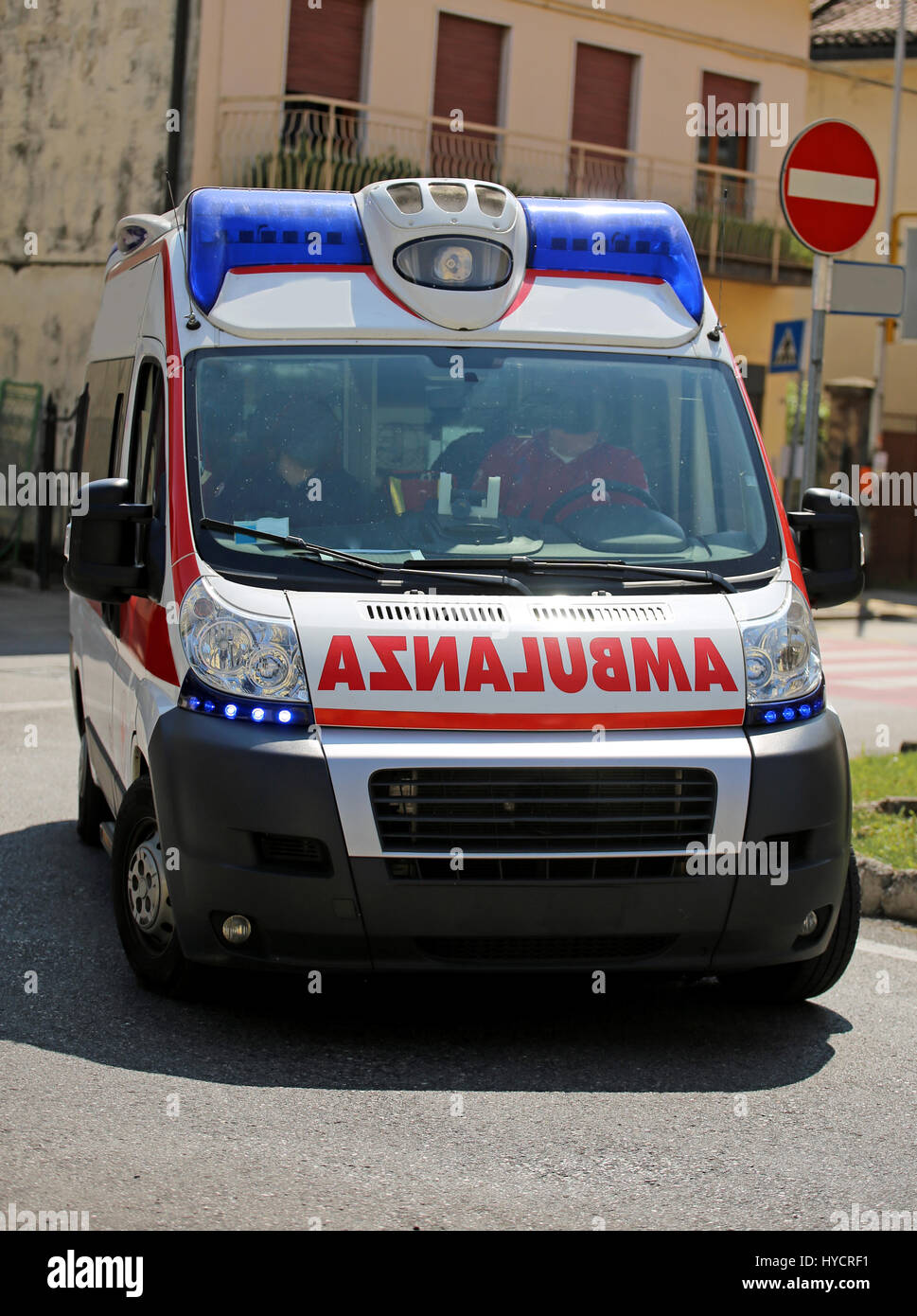 Ambulance on the city road during an emergency with blue sirens and the ...