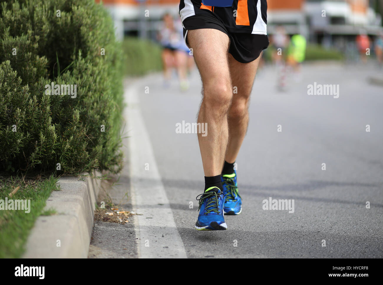athlete running during the marathon in the city Stock Photo - Alamy