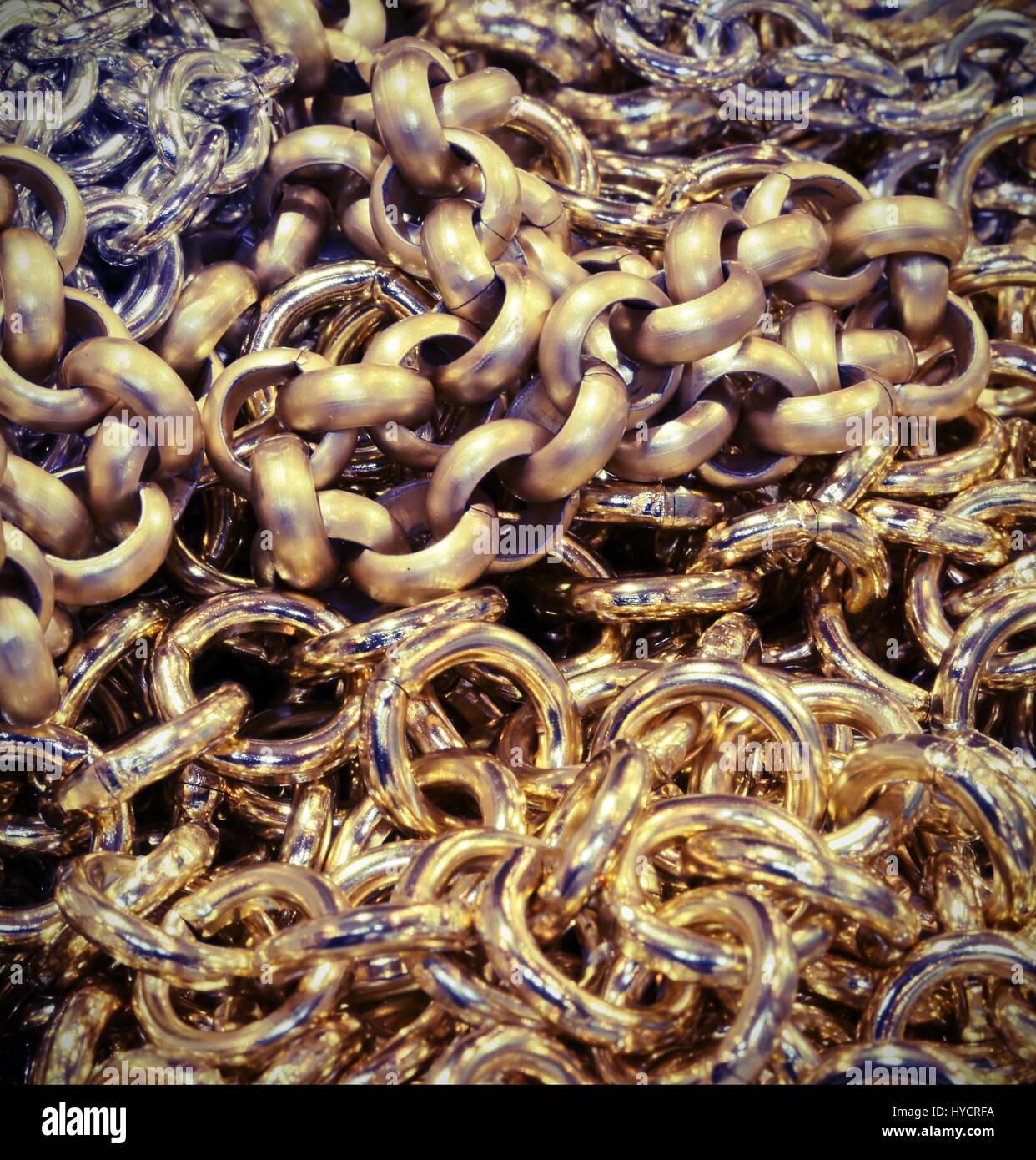background of many chains in gold and silver material with lomo effect ...