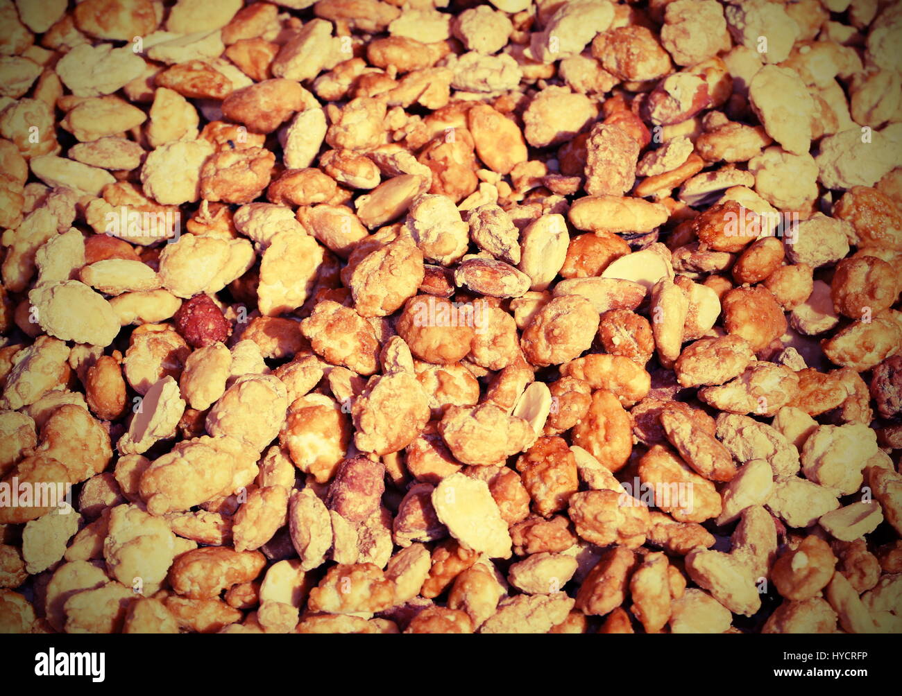 background with lots of brown roasted toasted peanuts and covered with ...
