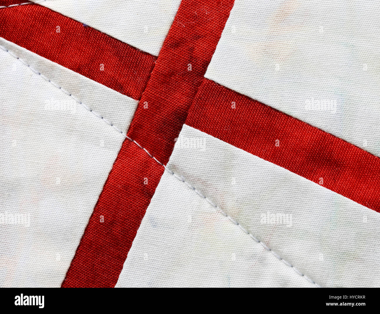 red embroidery typical of the medieval crusaders cross on a white ...