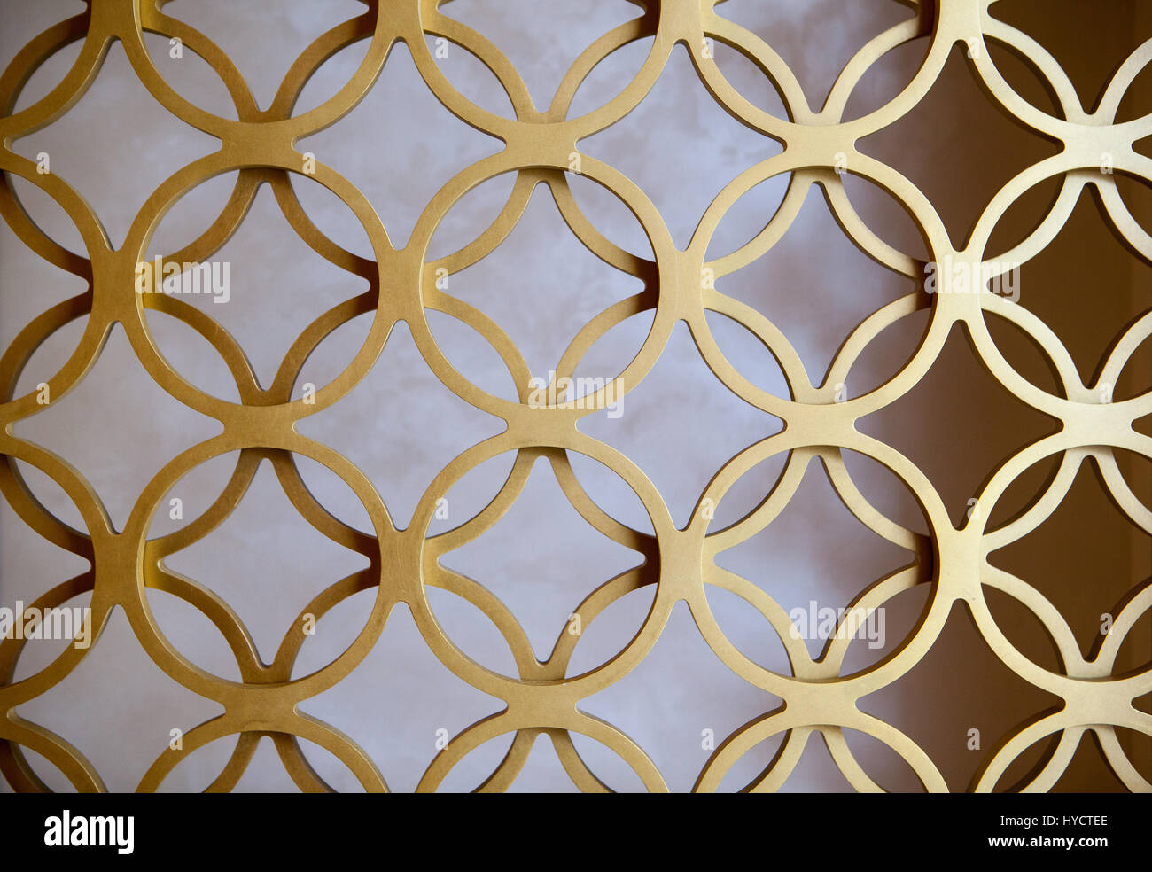 Orange painted circle perforated metal panels Stock Photo - Alamy