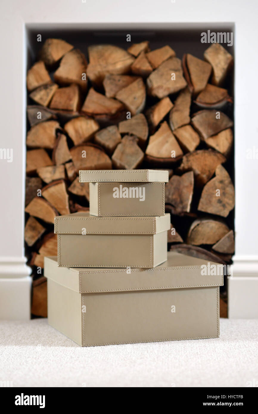 Tan leather storage boxes in front of chopped logs Stock Photo - Alamy