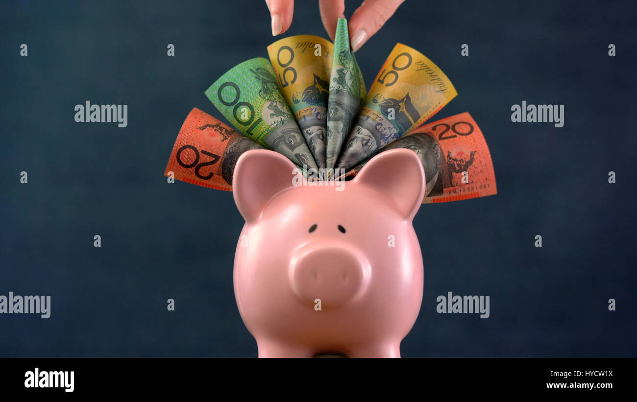 Australian money woman piggy bank hi-res stock photography and images ...
