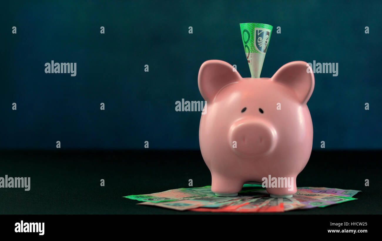 Pink Piggy bank money concept on dark blue background with Australian ...
