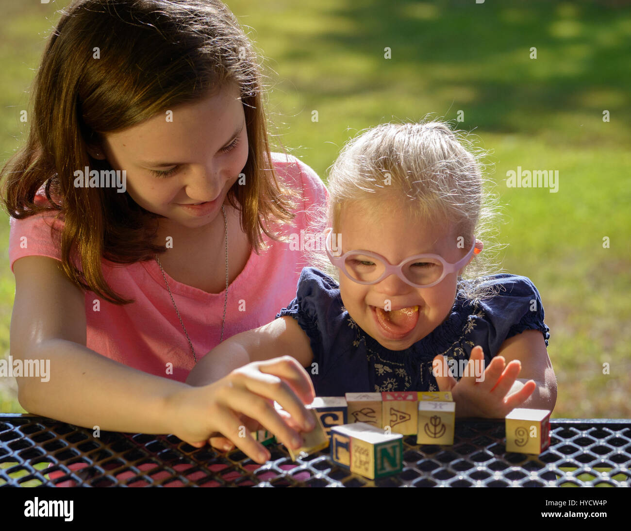 Sisters playing blocks/Down Syndrome Stock Photo - Alamy