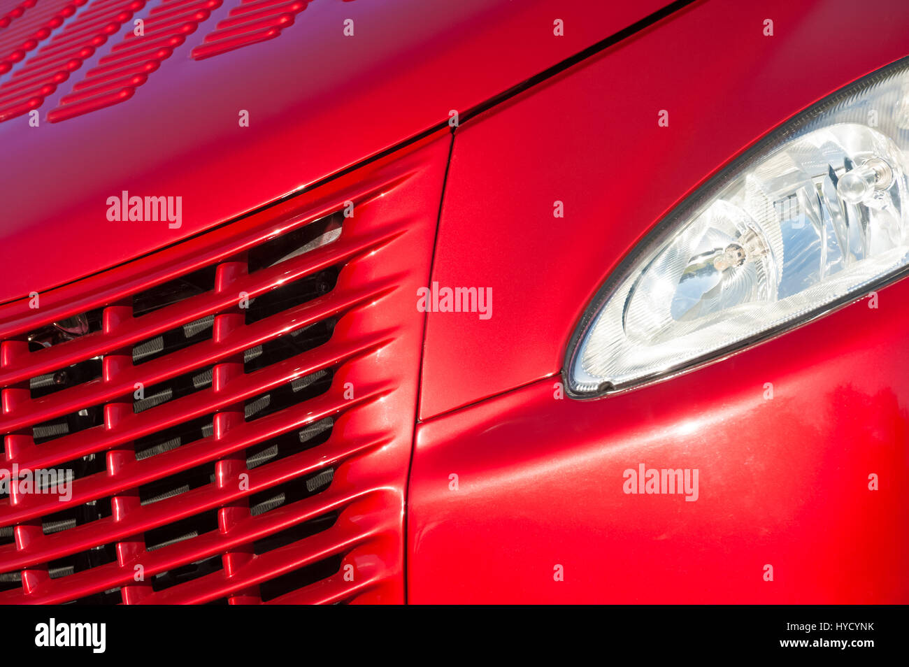 cherry red vehicle grille in bright sunlight Stock Photo - Alamy